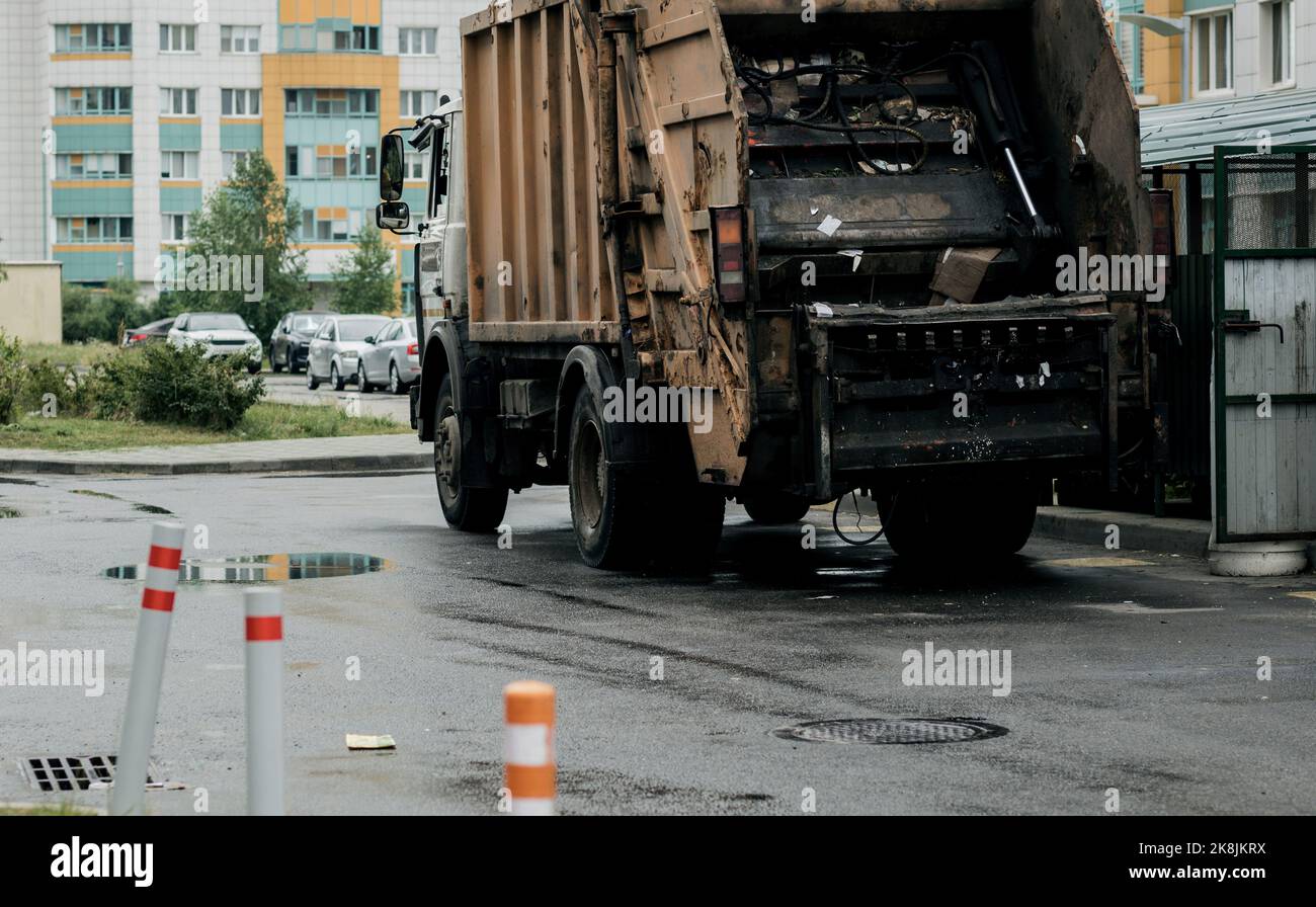 Garbage disposal lorry at city street. Waste dump truck on town road ...