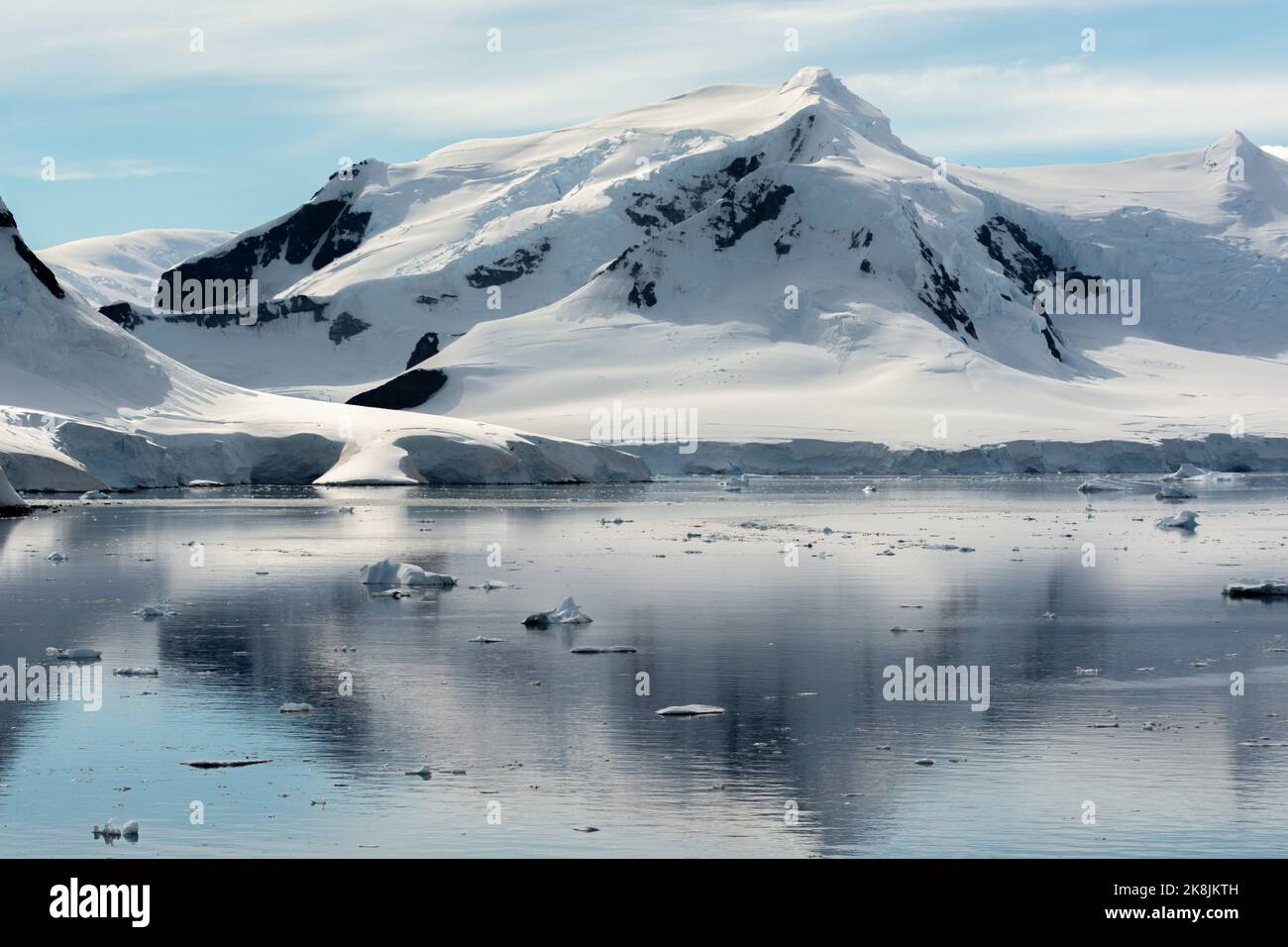 still waters of paradise harbour (bay) with munoz point (l) and mt ...
