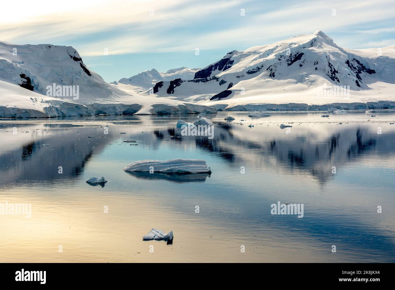 still waters of paradise harbour (bay) with lemaire island (l) and mt ...