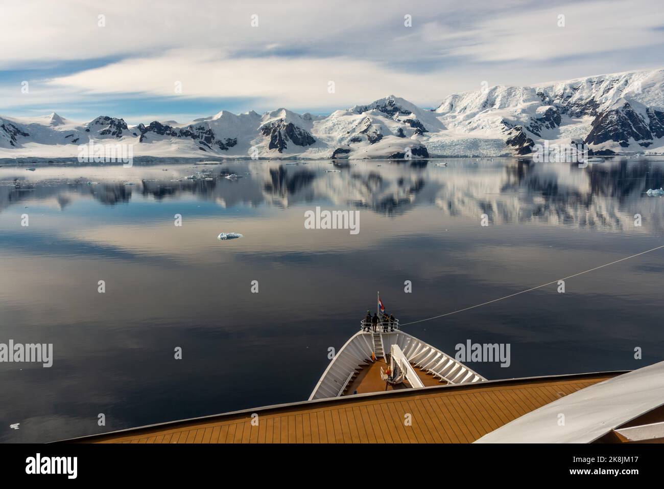 cruising in still waters of paradise harbour (bay) with peaks and ...