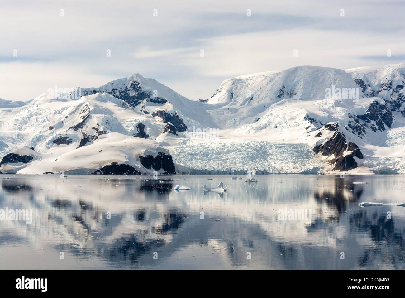 iceberg in still waters of paradise harbour (bay) with conesa point and ...