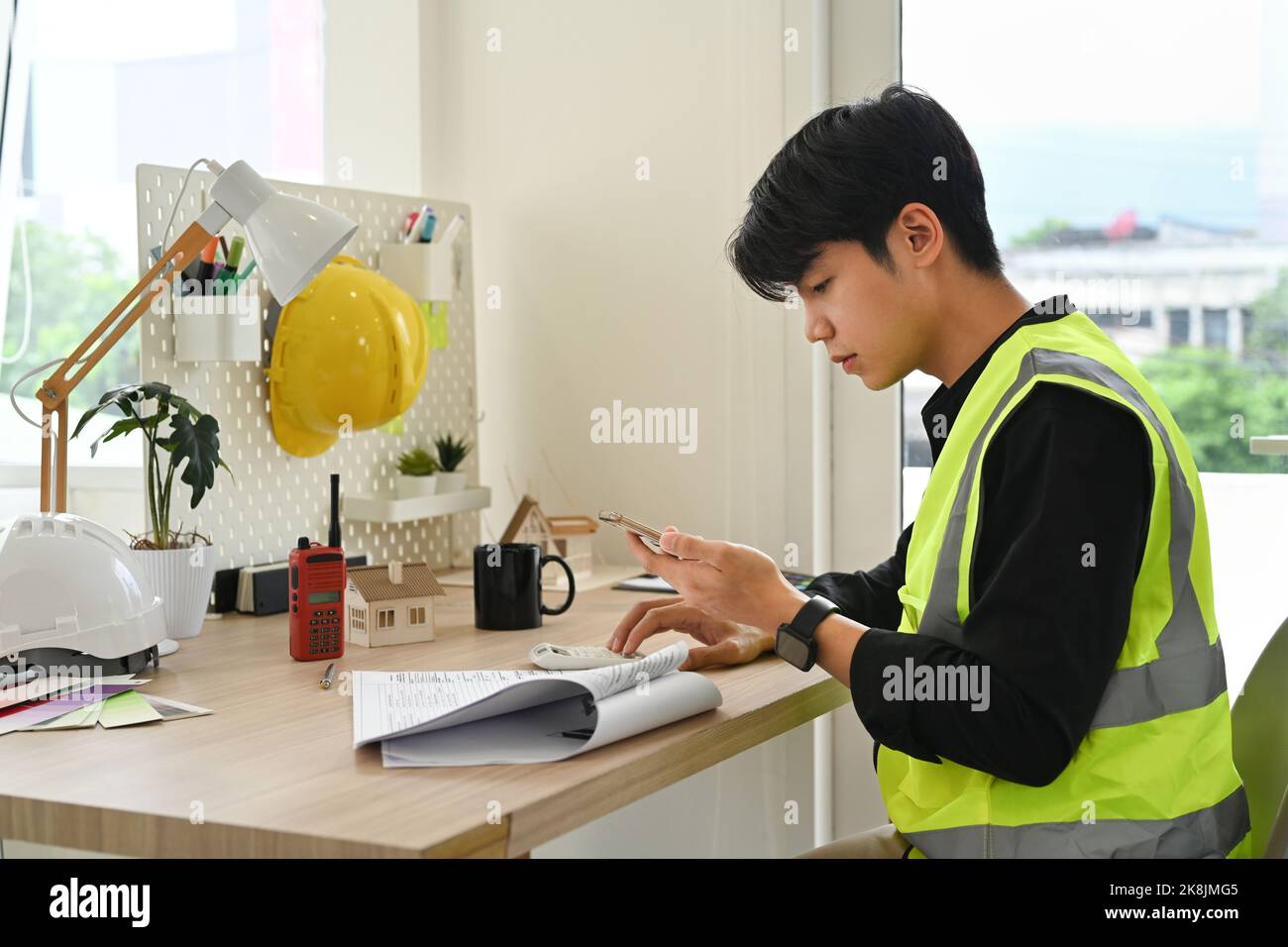 Young asian man working on the design of a construction plan or ...