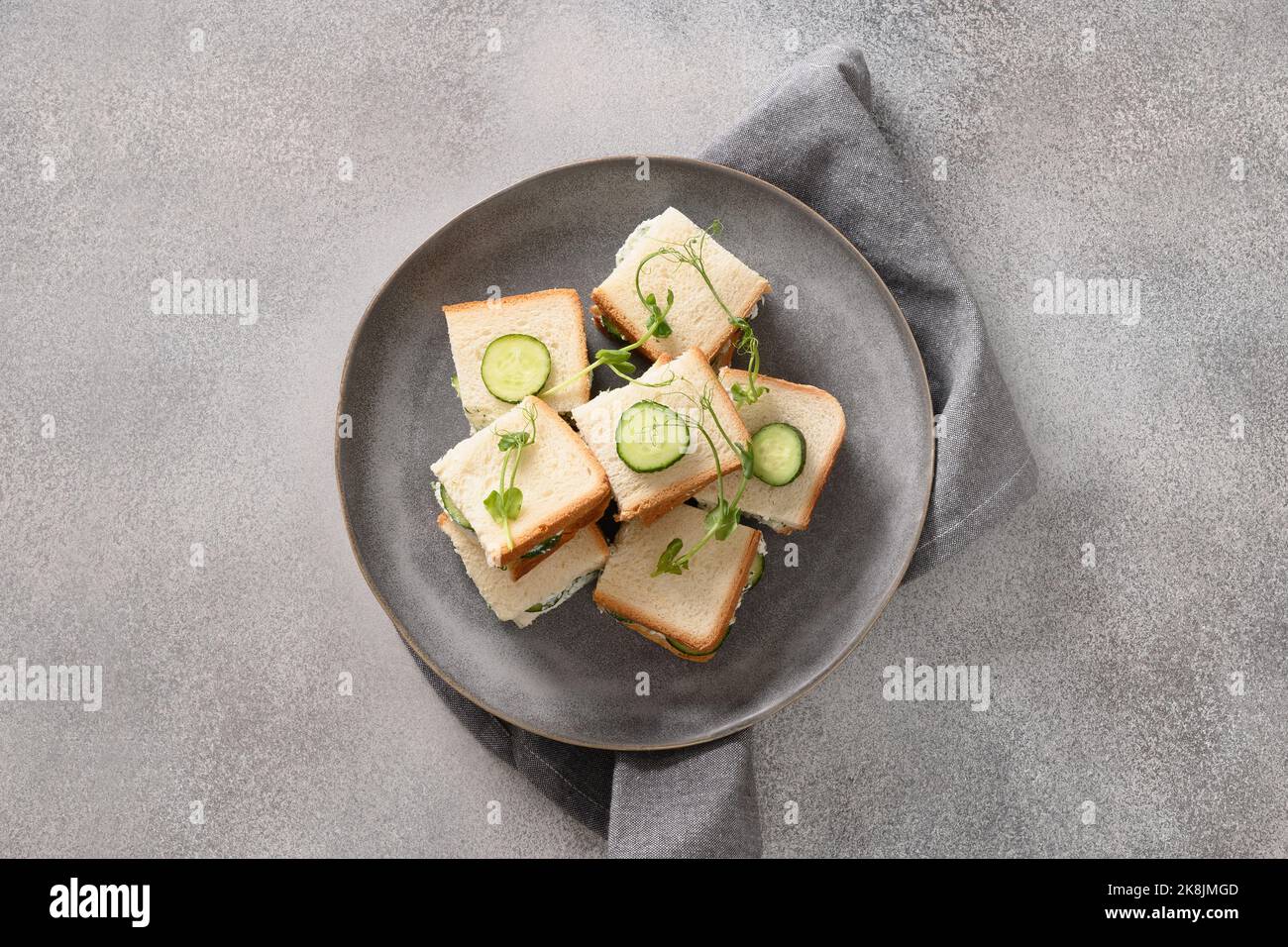 Homemade English tea cucumber sandwiches with ricotta and dill on gray ...