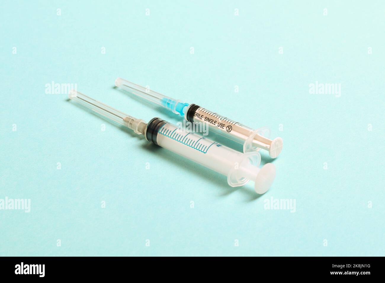 Top view of different syringes for injection on colorful background ...