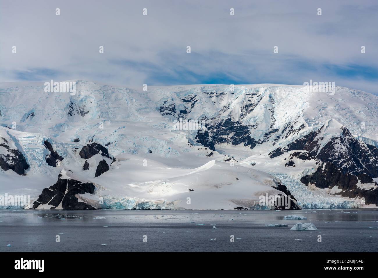 snow covered peaks of danco coast from paradise harbour (bay ...