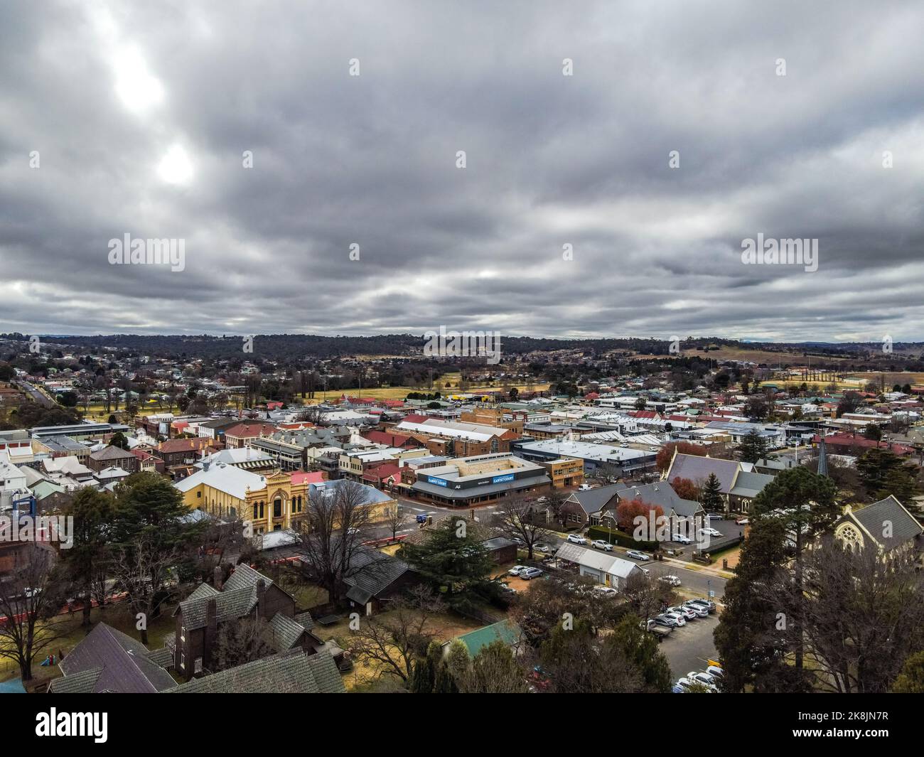 An aerial view of the town of Armidale with buildings and traffic on ...
