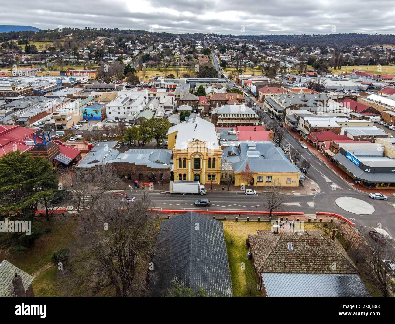 An aerial view of the town of Armidale with buildings and traffic on ...