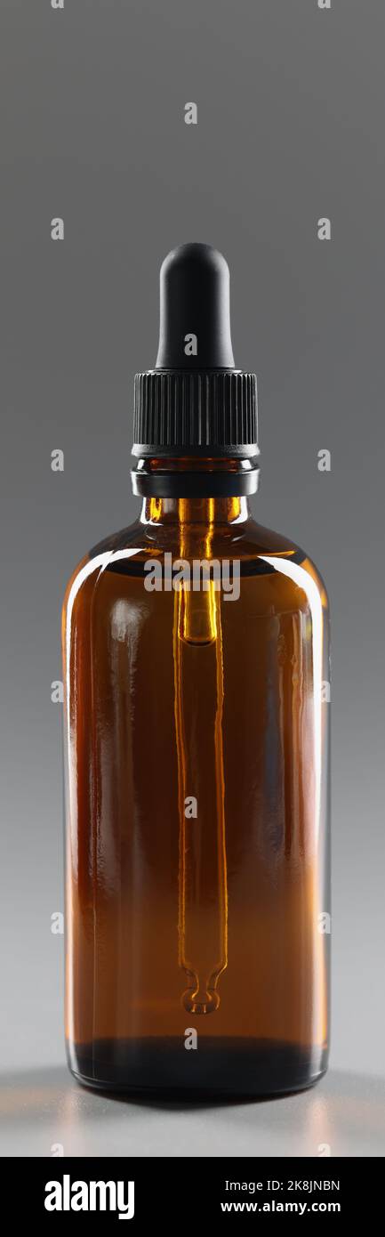Brown glass bottle filled with oil, flask with cosmetology product or ...