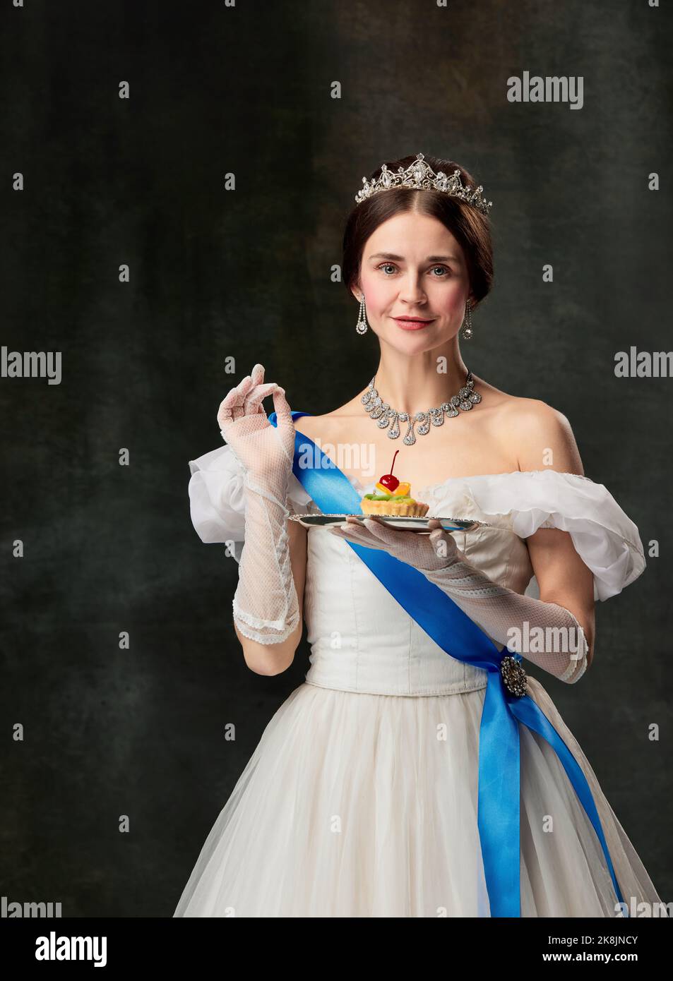 Sweet delight. Elegant woman, royal person, queen or princess in white ...