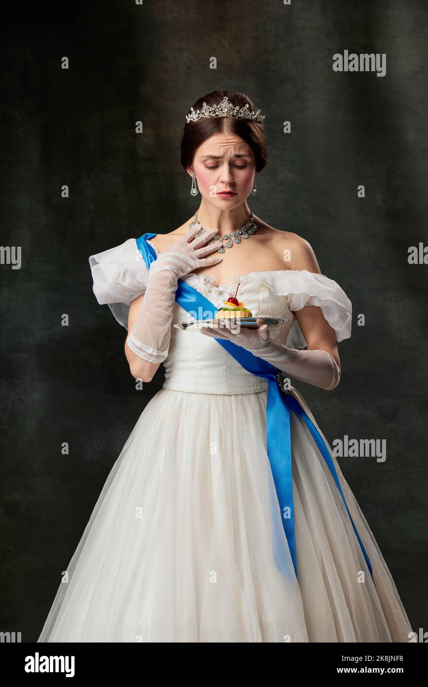 Royal diet. Elegant sad woman, royal person, queen or princess in white ...