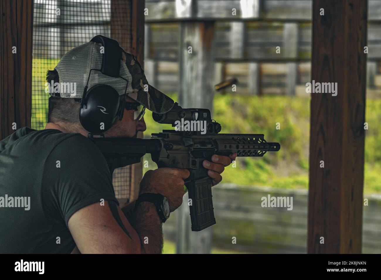 A man shooting a gun at a shooting range in London Stock Photo - Alamy