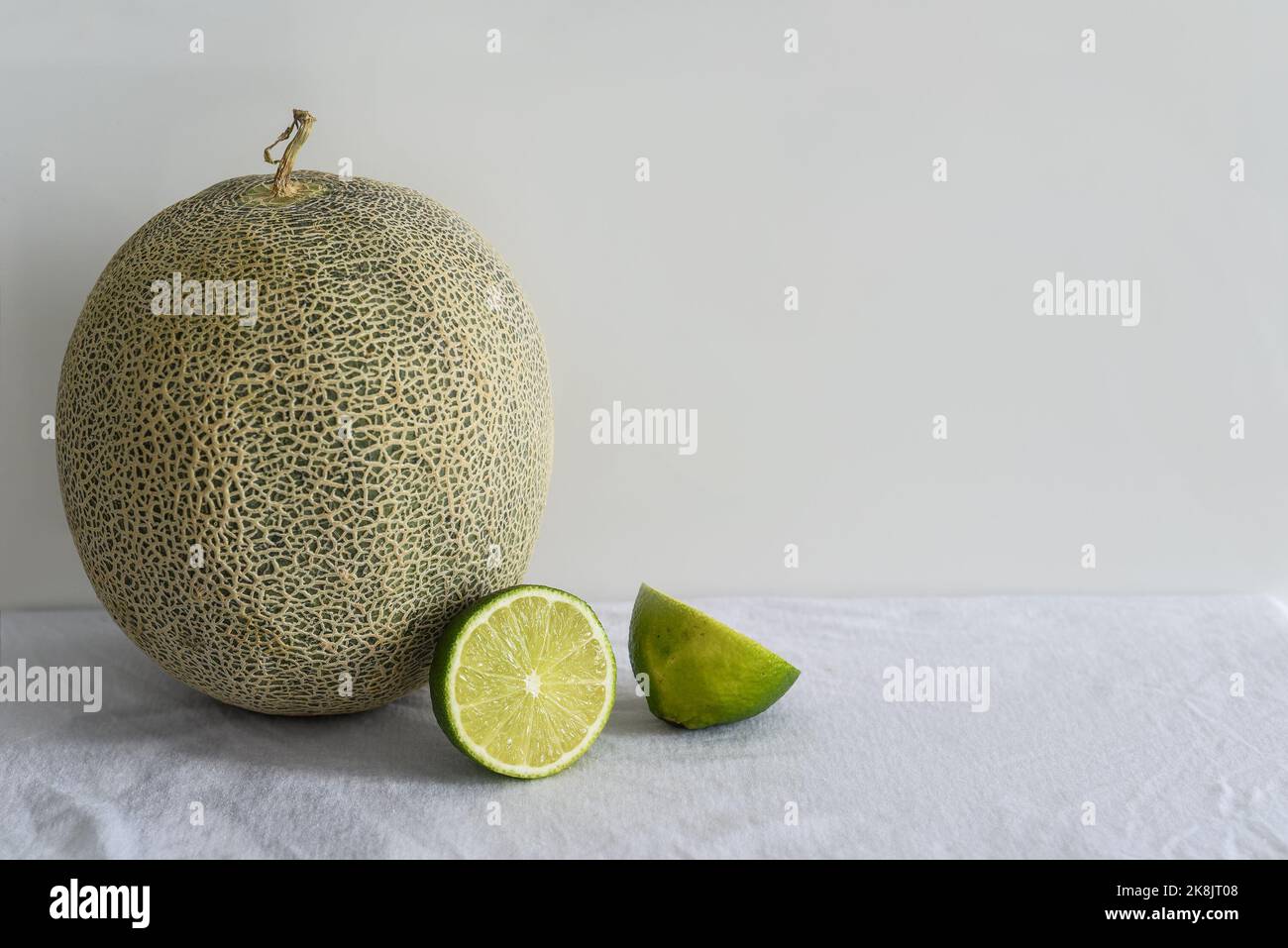 Melon and lime fruits on white background Stock Photo - Alamy