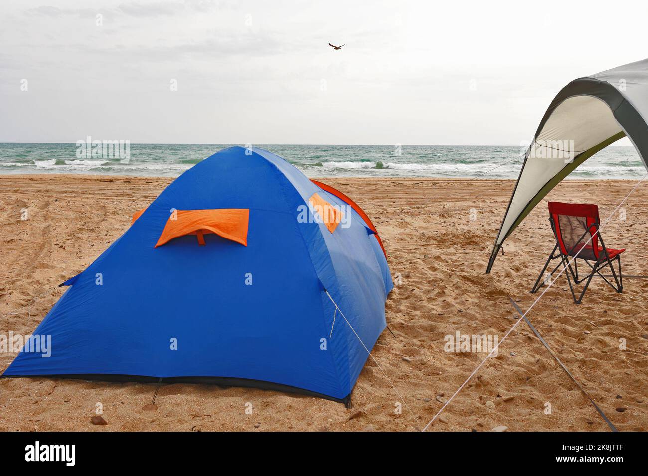 Camping by the sea with a tent, an awning and a sun lounger Stock Photo ...