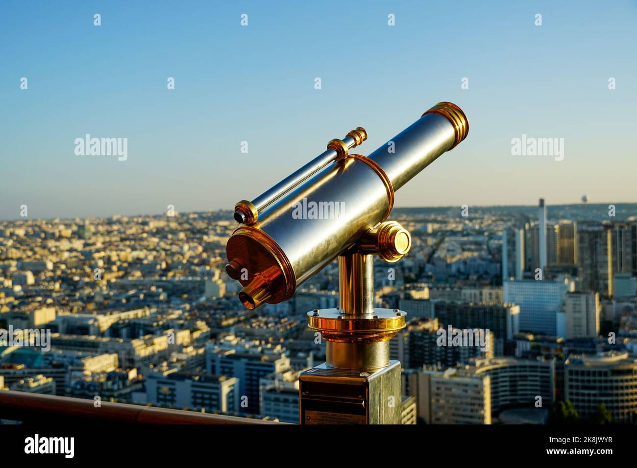 A telescope outdoors with a cityscape in the background Stock Photo - Alamy