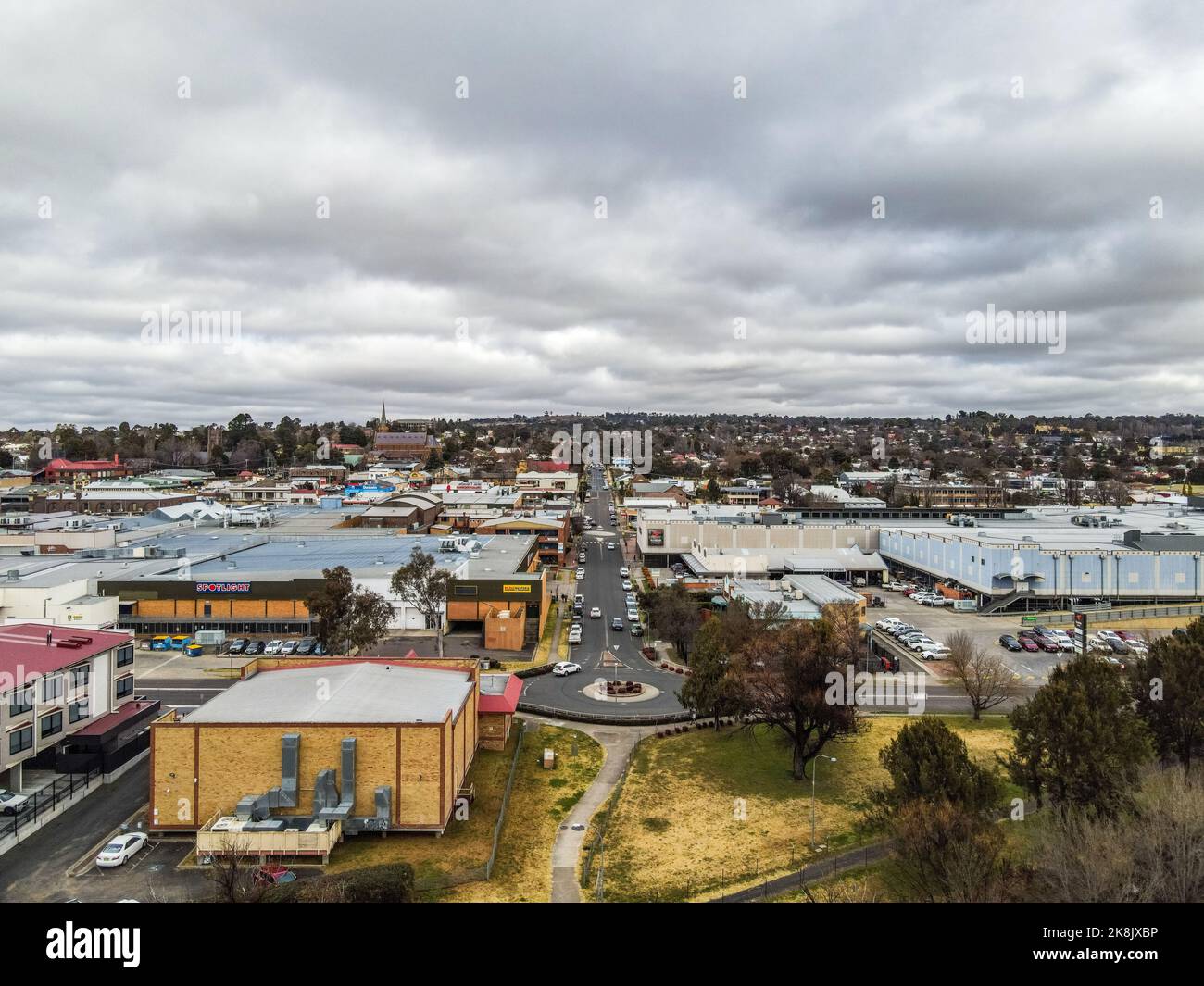 An aerial shot of country town buildings, street, cars, clouds and the ...