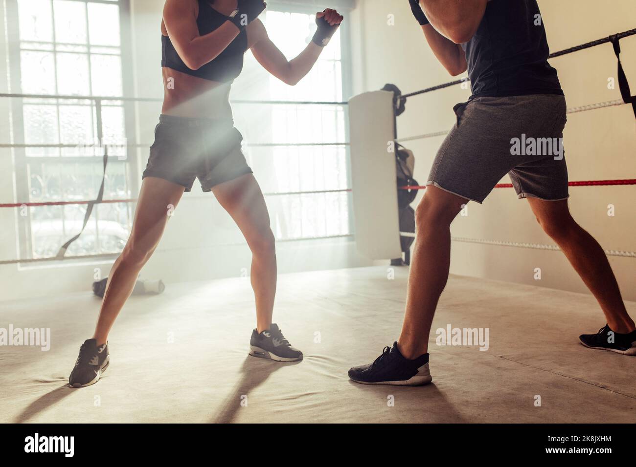 Low angle view of two young boxers fighting in a boxing ring. Two young ...