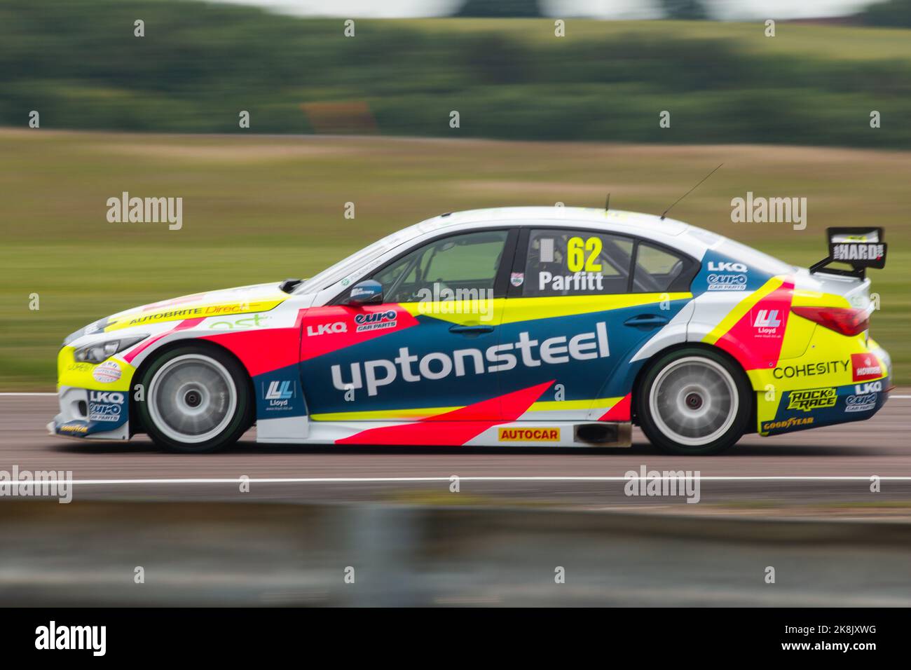 A British Touring Car on the track at Thruxton with blurred background ...
