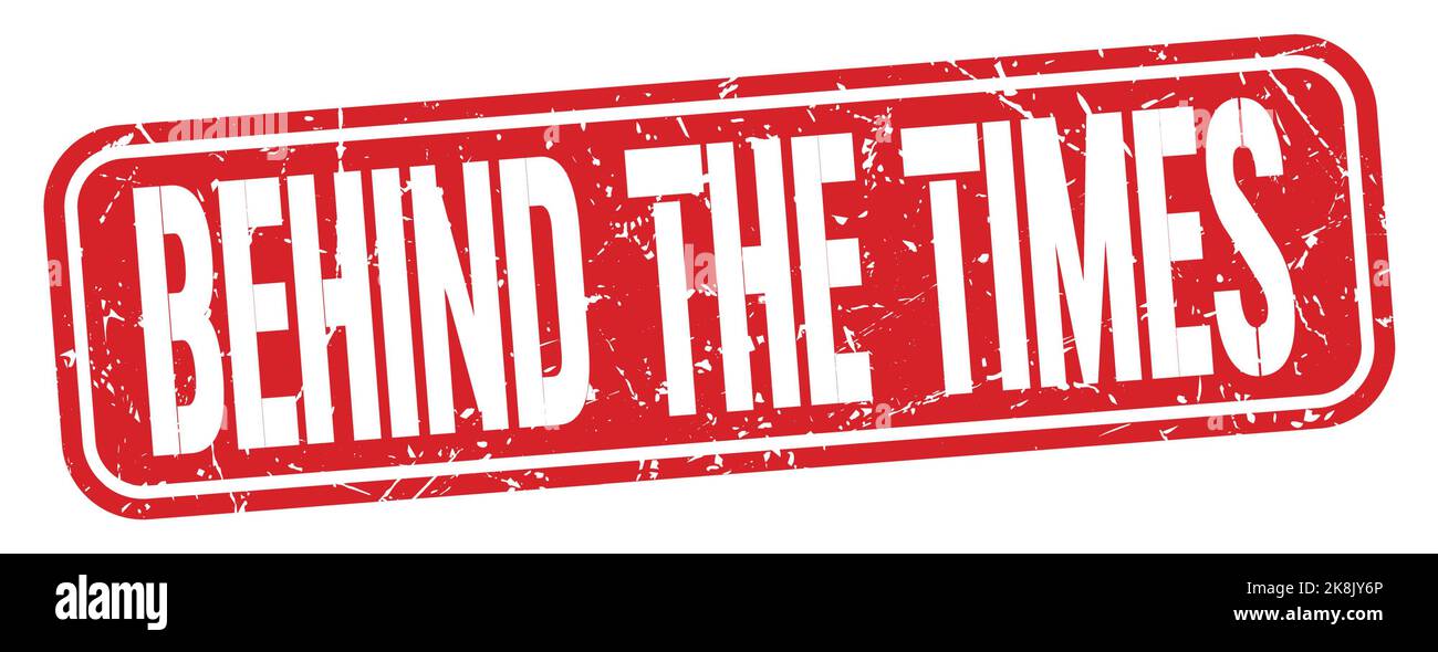 BEHIND THE TIMES text written on red grungy stamp sign Stock Photo - Alamy