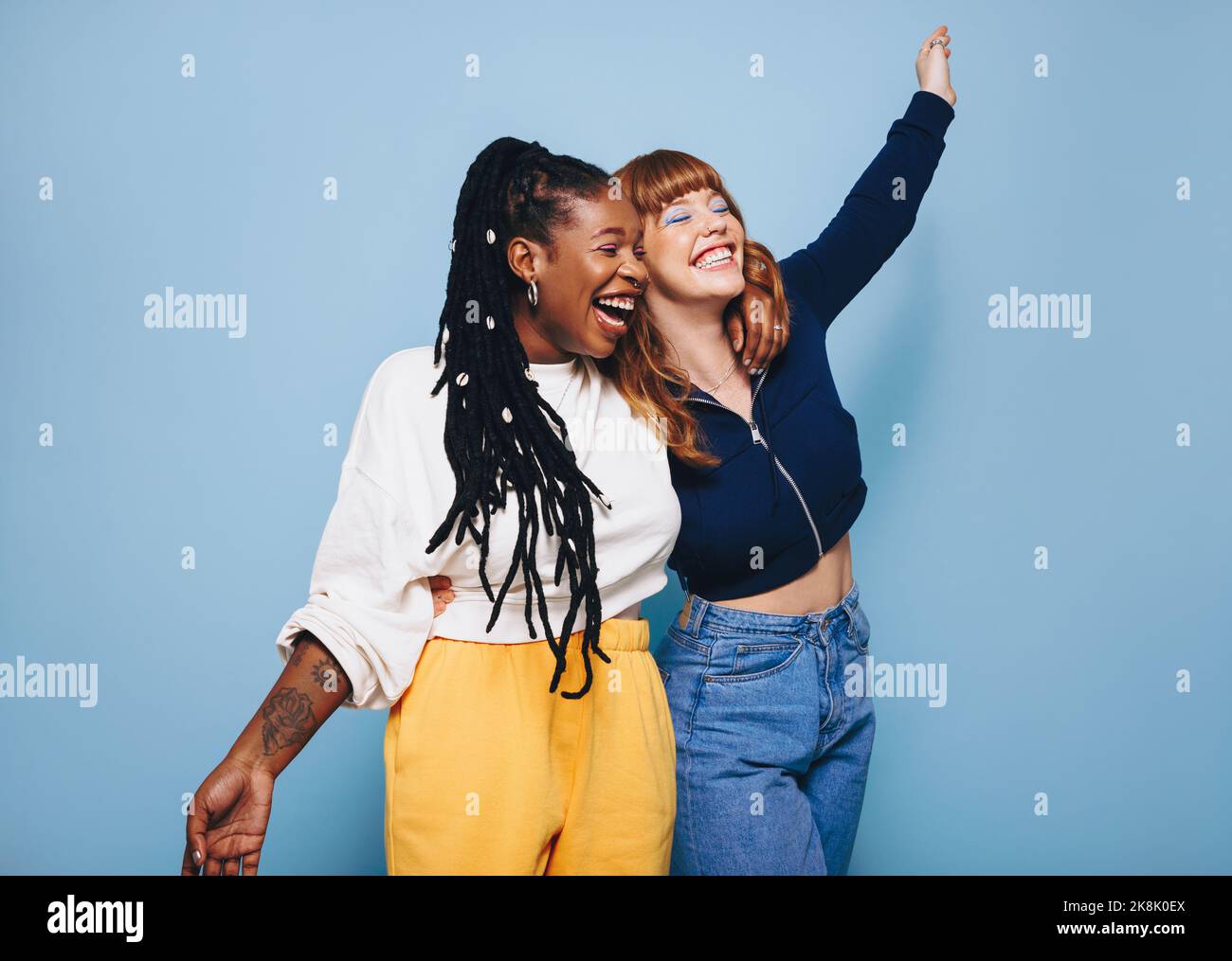 Two best friends laughing and having fun while embracing each other in ...