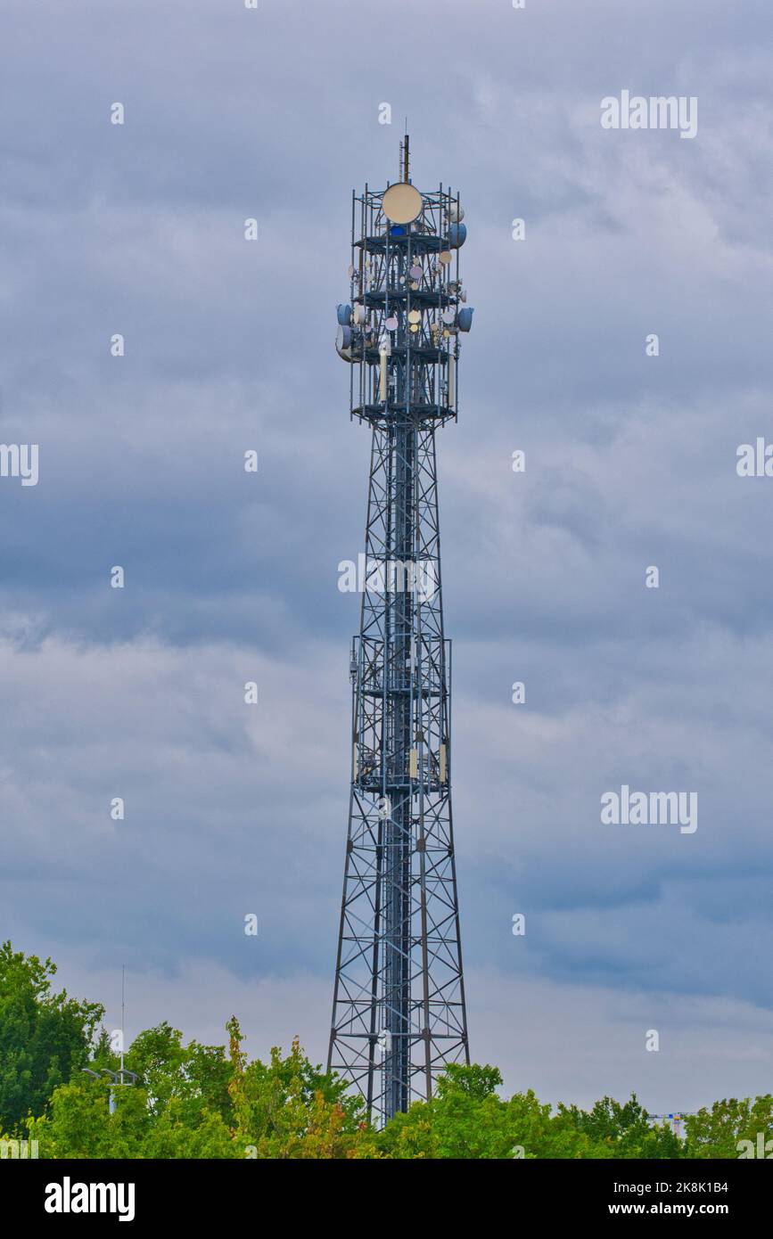 A telecommunications tower with many antennas, steel structure tower and blue cloudy sky Stock ...