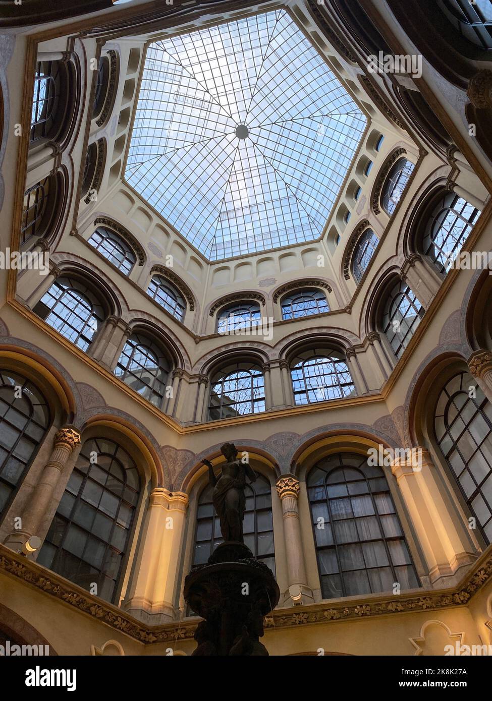 A glass, hexagon ceiling of a historical building and a sculpture, low angle, vertical Stock ...