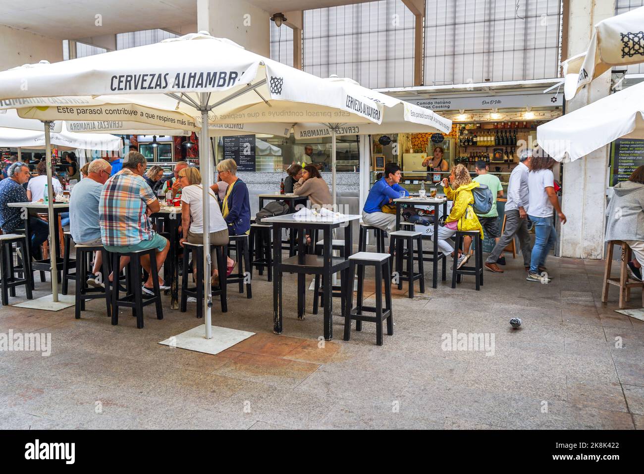 Visitors eating at food stalls inside the Cadiz covered food market ...