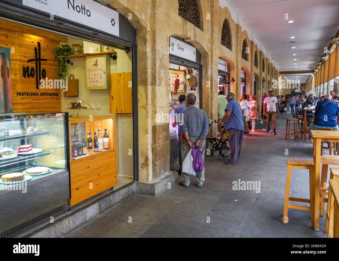 Visitors eating at food stalls inside the Cadiz covered food market ...