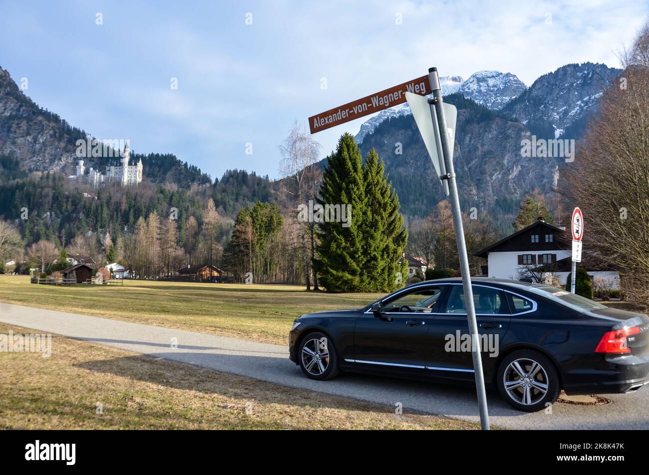 A black car with the beautiful New Swan Castle (Neuschwanstein Castle ...