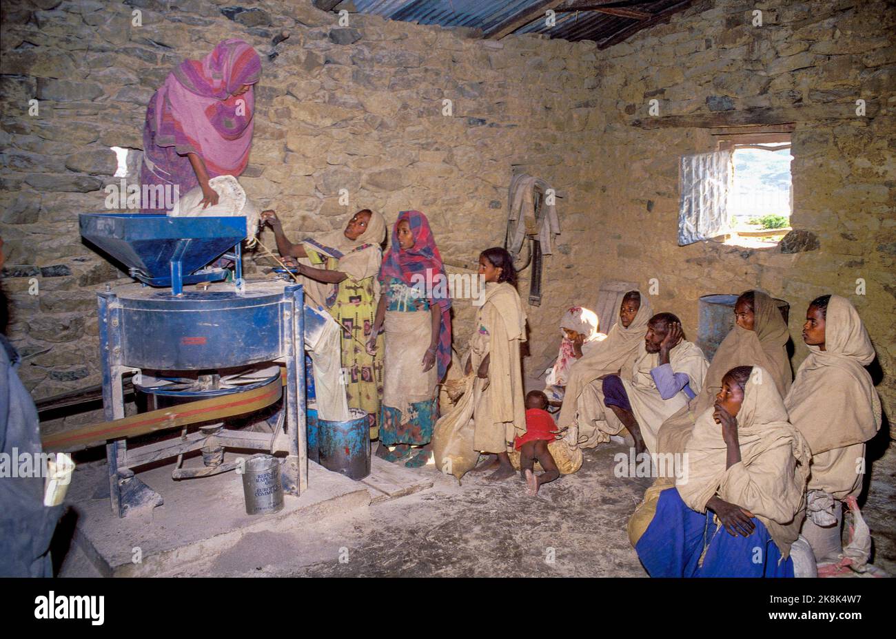 Ethiopia, Tigray - women working at a grain machine, producing flour ...