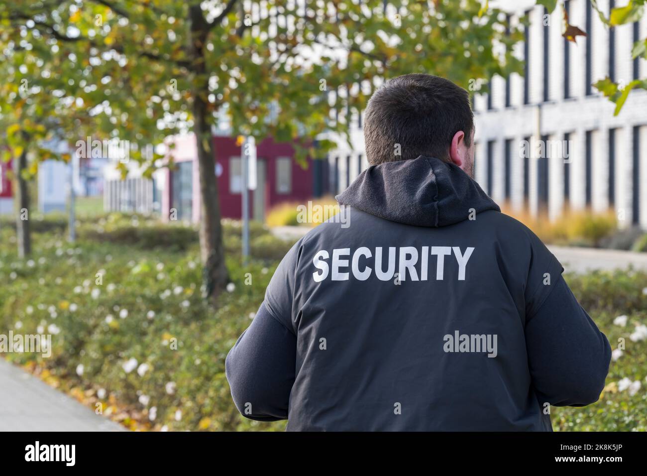 Security lettering on the vest of an employee Stock Photo - Alamy
