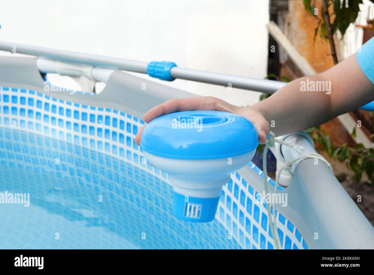 Worker hands isinfection and chlorination of water in the pool ...