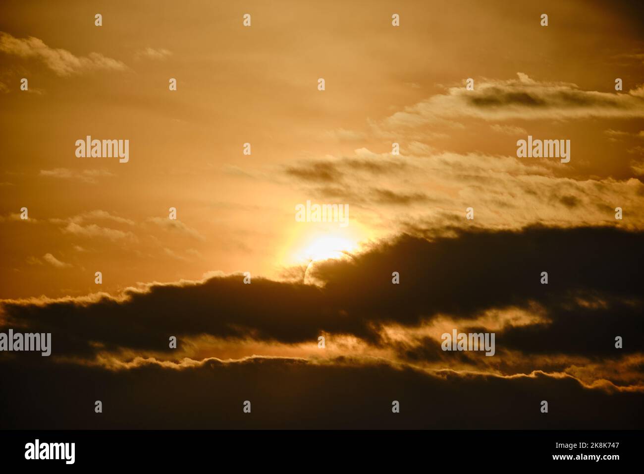 Evening dramatic sky with clouds during sunset. The sun sets behind dark clouds Stock Photo - Alamy
