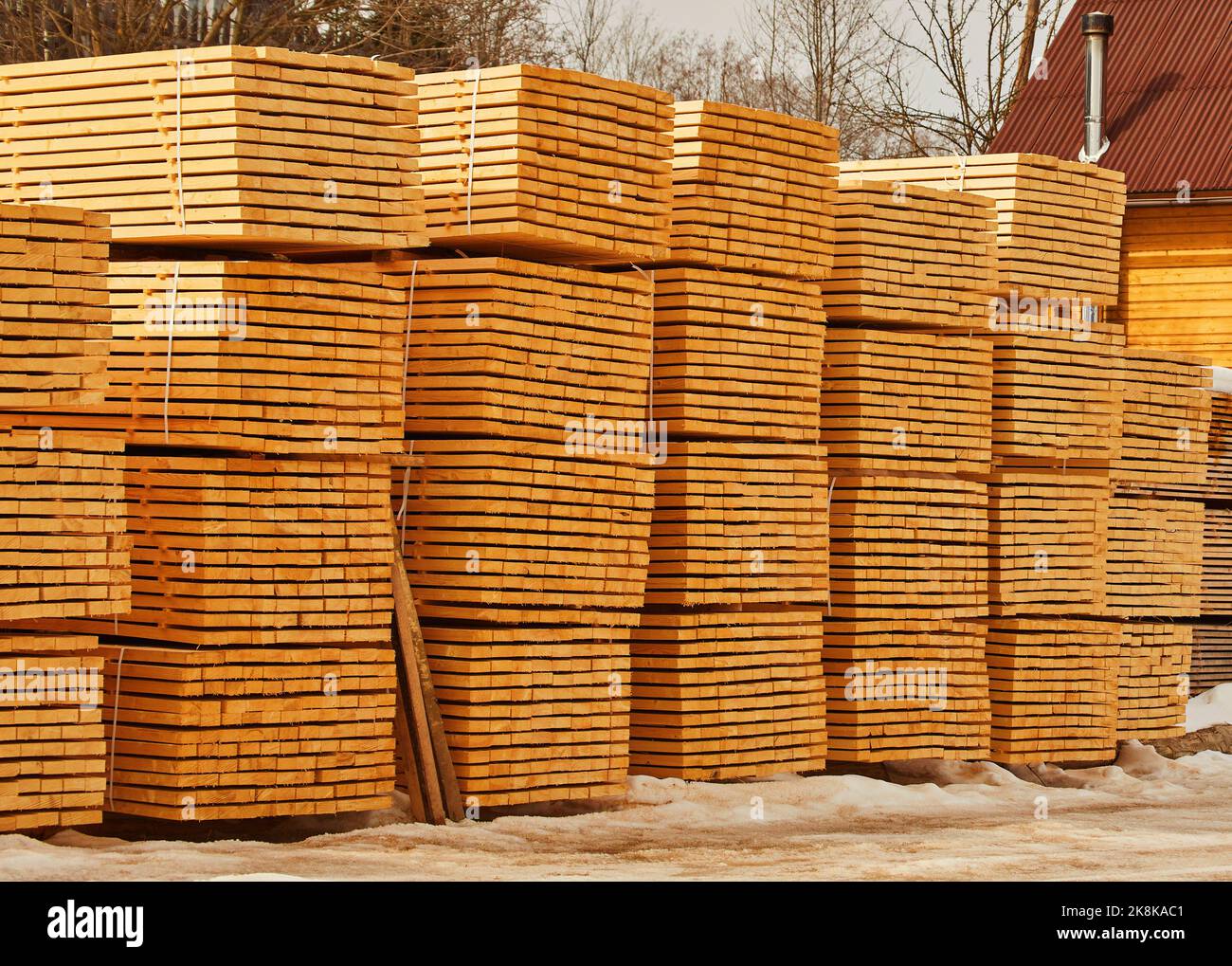 Wood boards piles stored outdoor, lumber storage. Stacked wooden boards ...