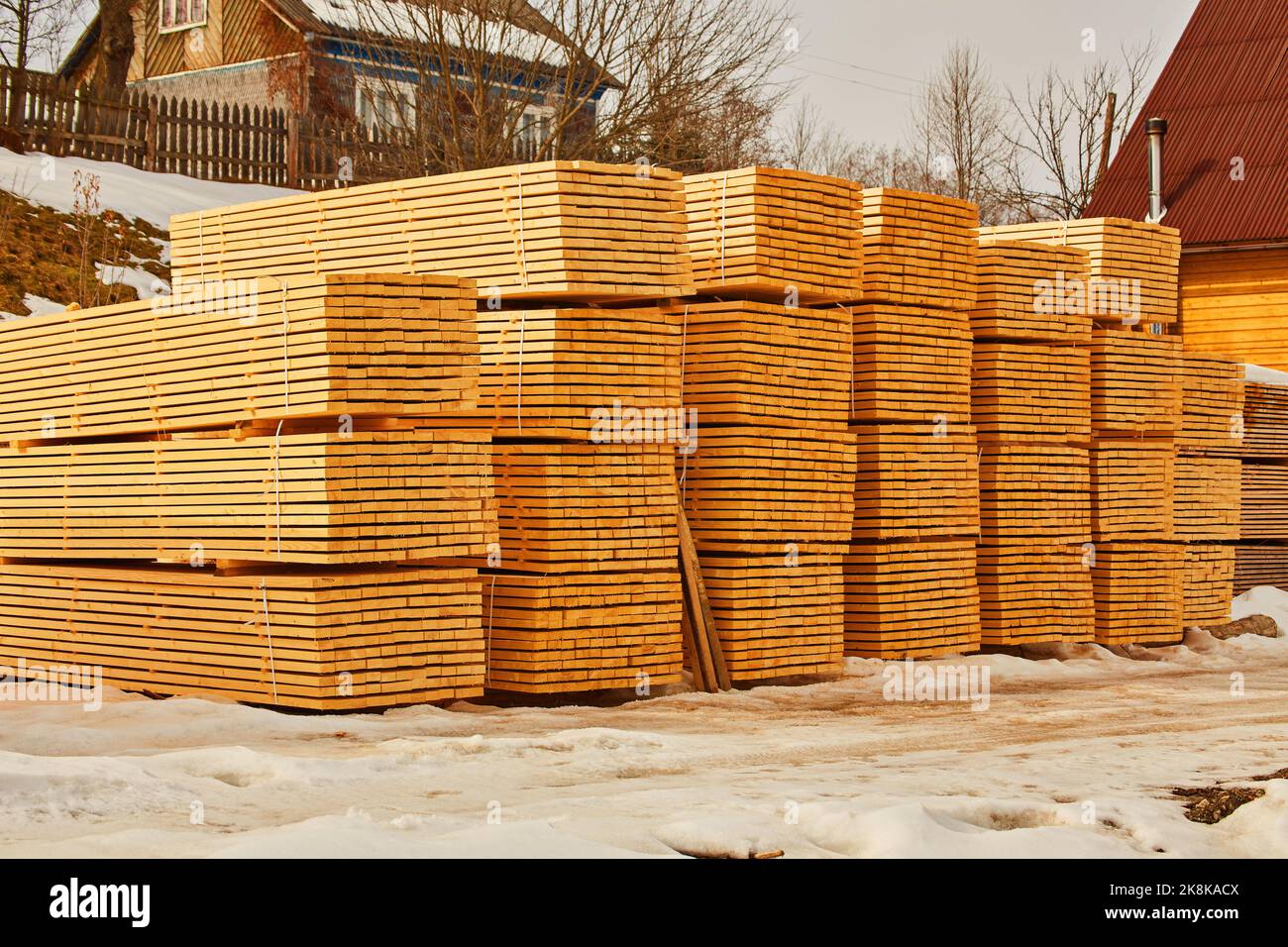 Stack of fresh pine boards in a sawmill warehouse. Harvesting, sale of ...