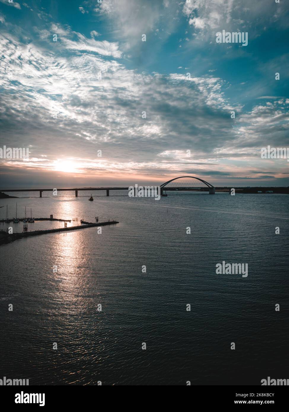 A vertical shot of Fehmarn Sound Bridge in the Baltic Sea at ...