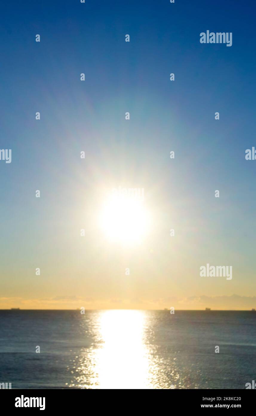 Blurred background. Sun shining in blue sky during sunset dawn. Sunrise ...