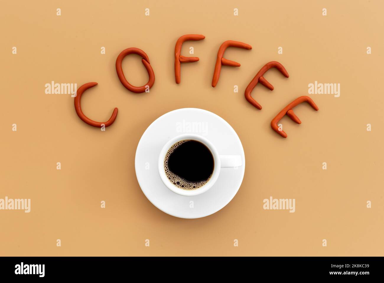 White cup of hot black coffee with rubber letters. Coffee break concept ...