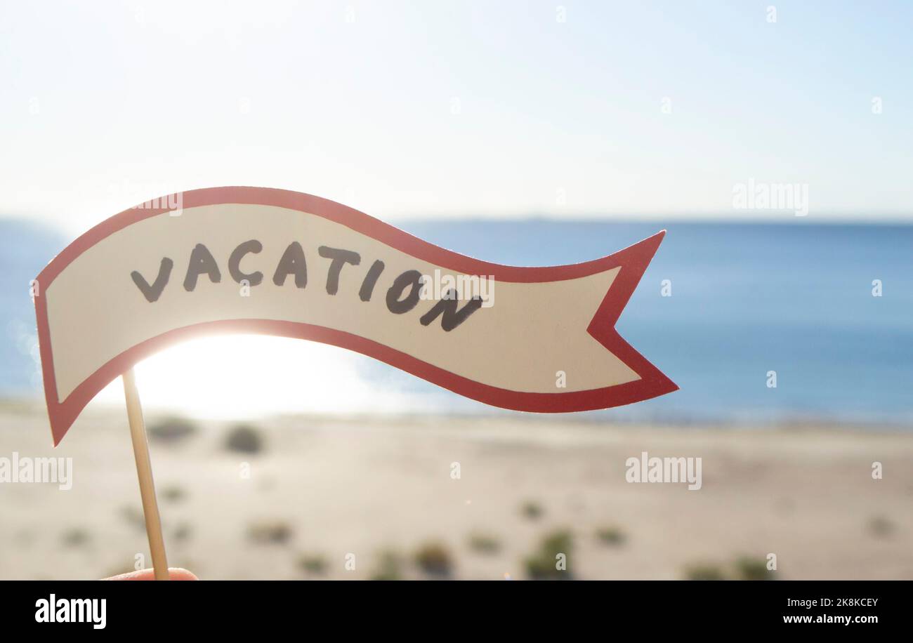 Stick with paper speech bubble with words Vacation on background sea ...