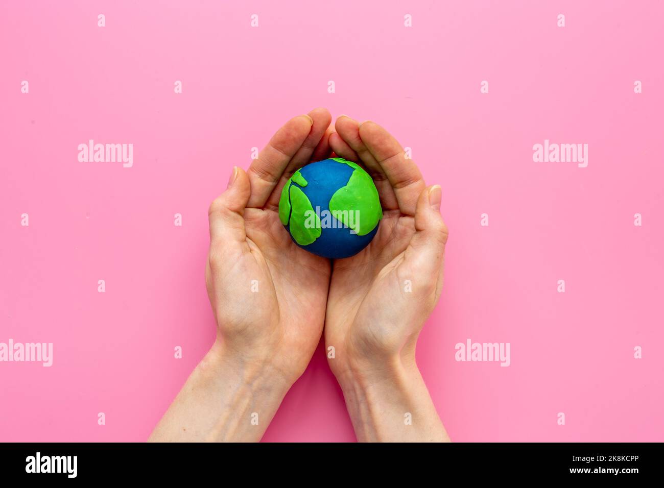 Plasticine world - planet Earth in hands. Eco care concept Stock Photo ...