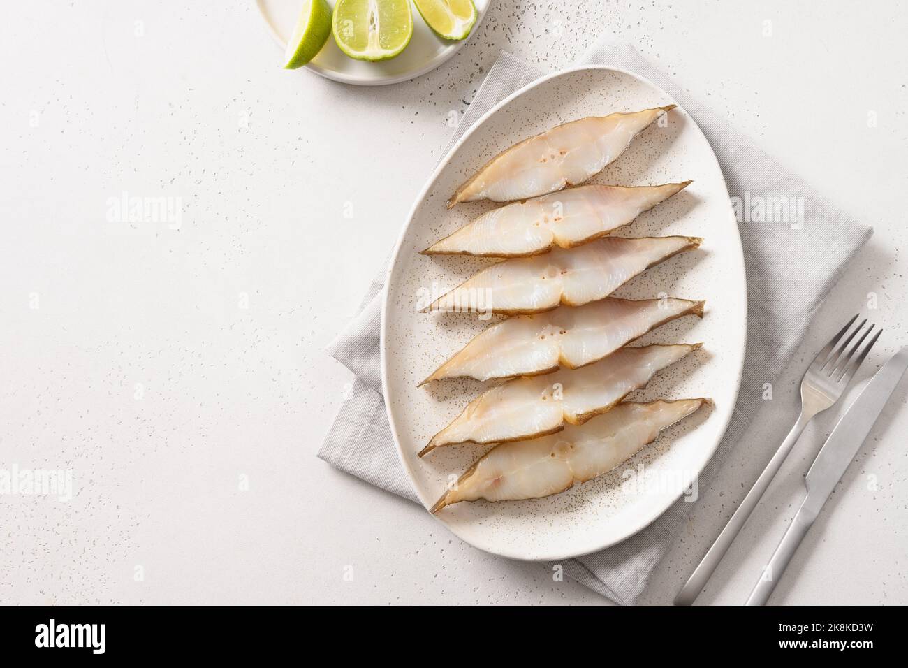 Smoked halibut slices on white background. View from above. Copy space ...