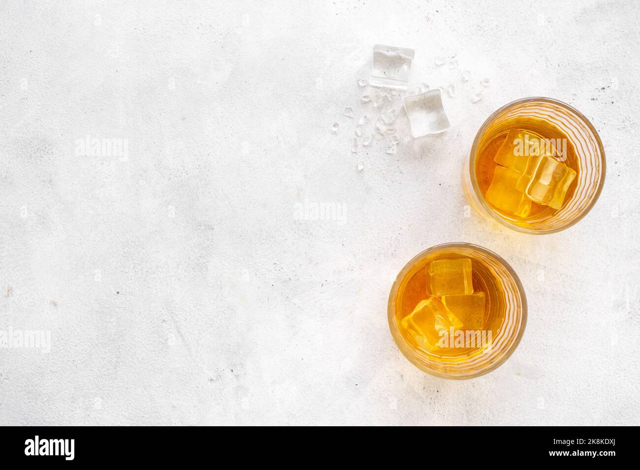 Glass of whiskey or brandy with ice. Strong alcohol background Stock ...