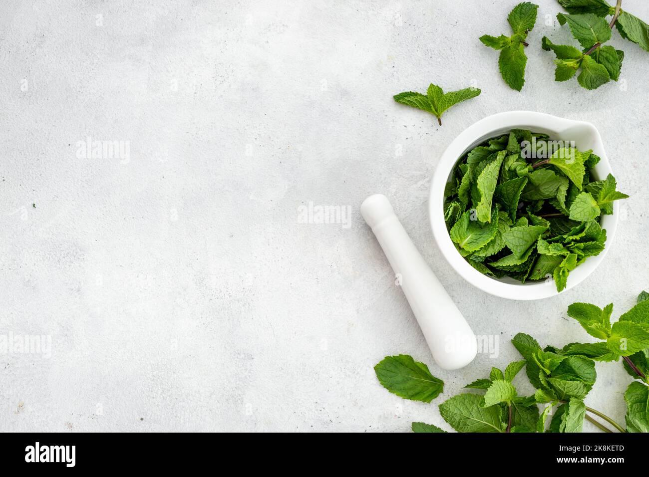 Healing herbs - green mint leaves in mortar for medicine Stock Photo ...