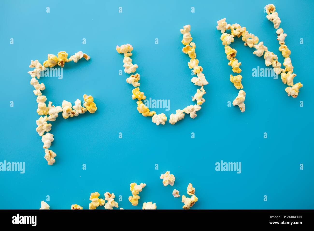 Food. Word of Fun. Popcorn bucket. Delicious Popcorn on Blue Background ...