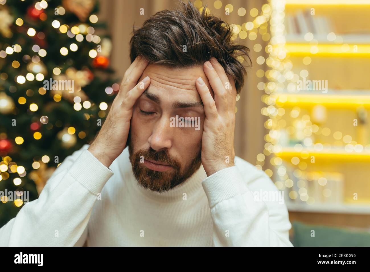 A man has a headache for Christmas, a close-up photo on New Year's Eve ...
