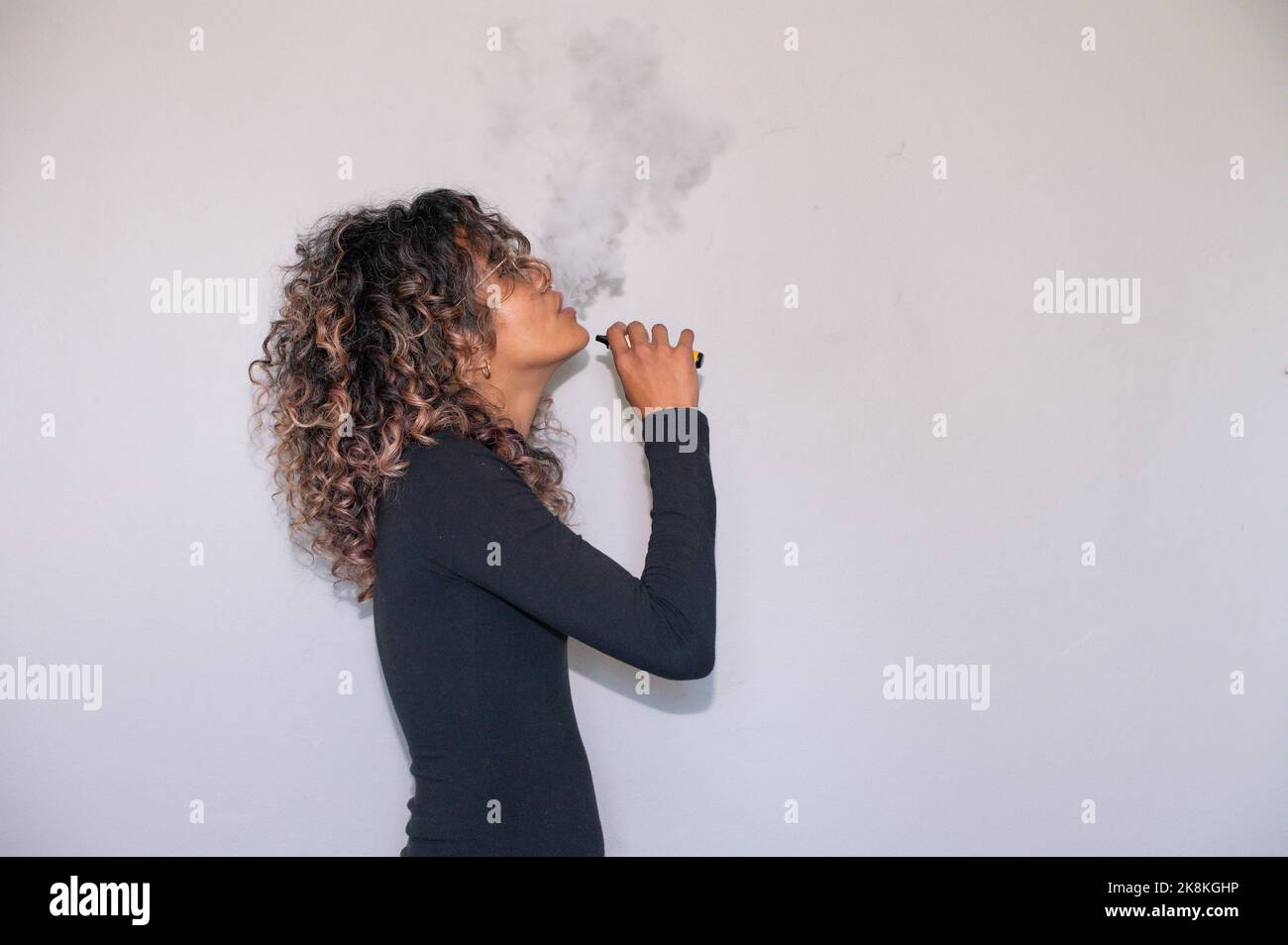 Portrait of woman using vape Stock Photo - Alamy