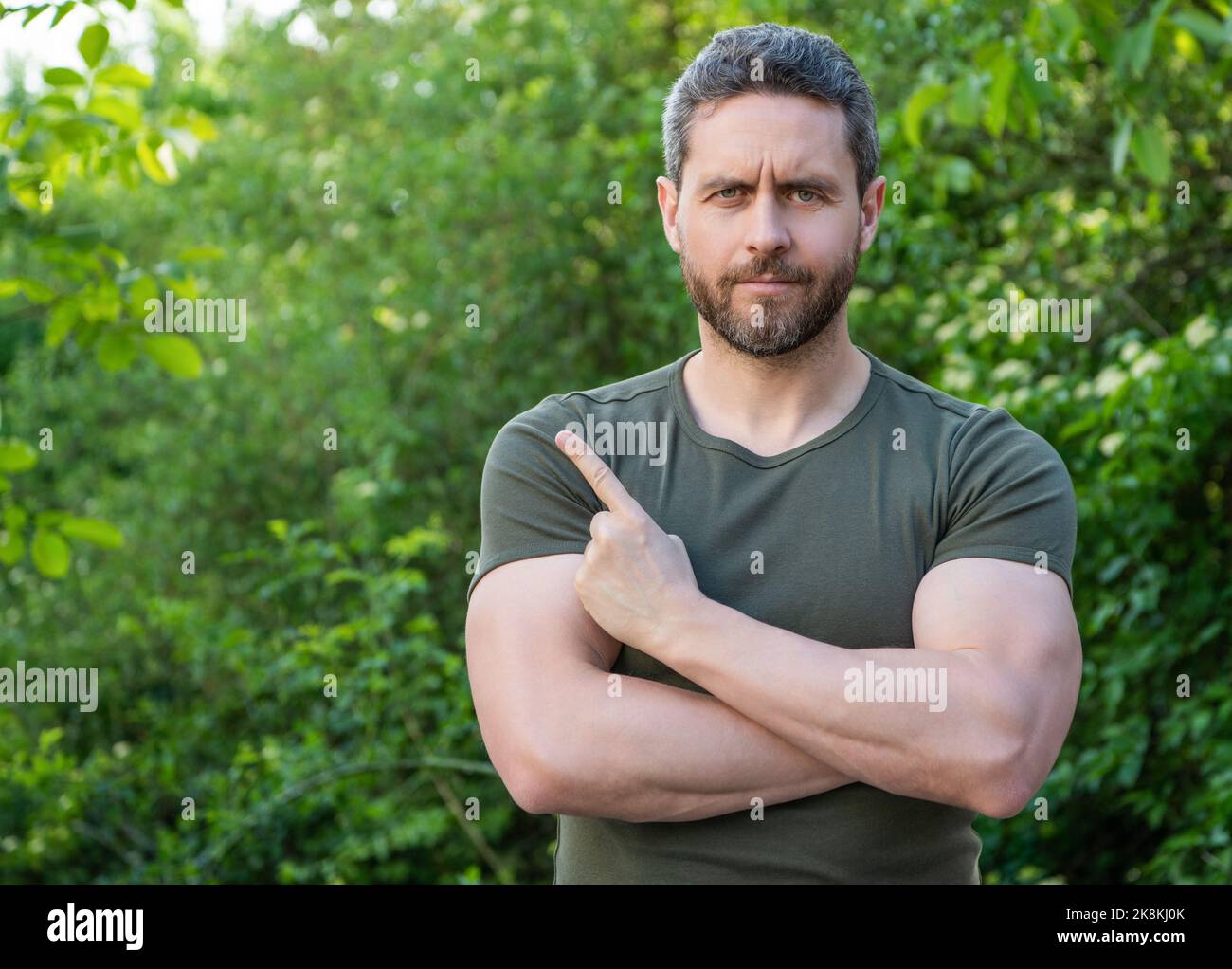 man pointing finger. guy pointing finger on copy space. adult man ...