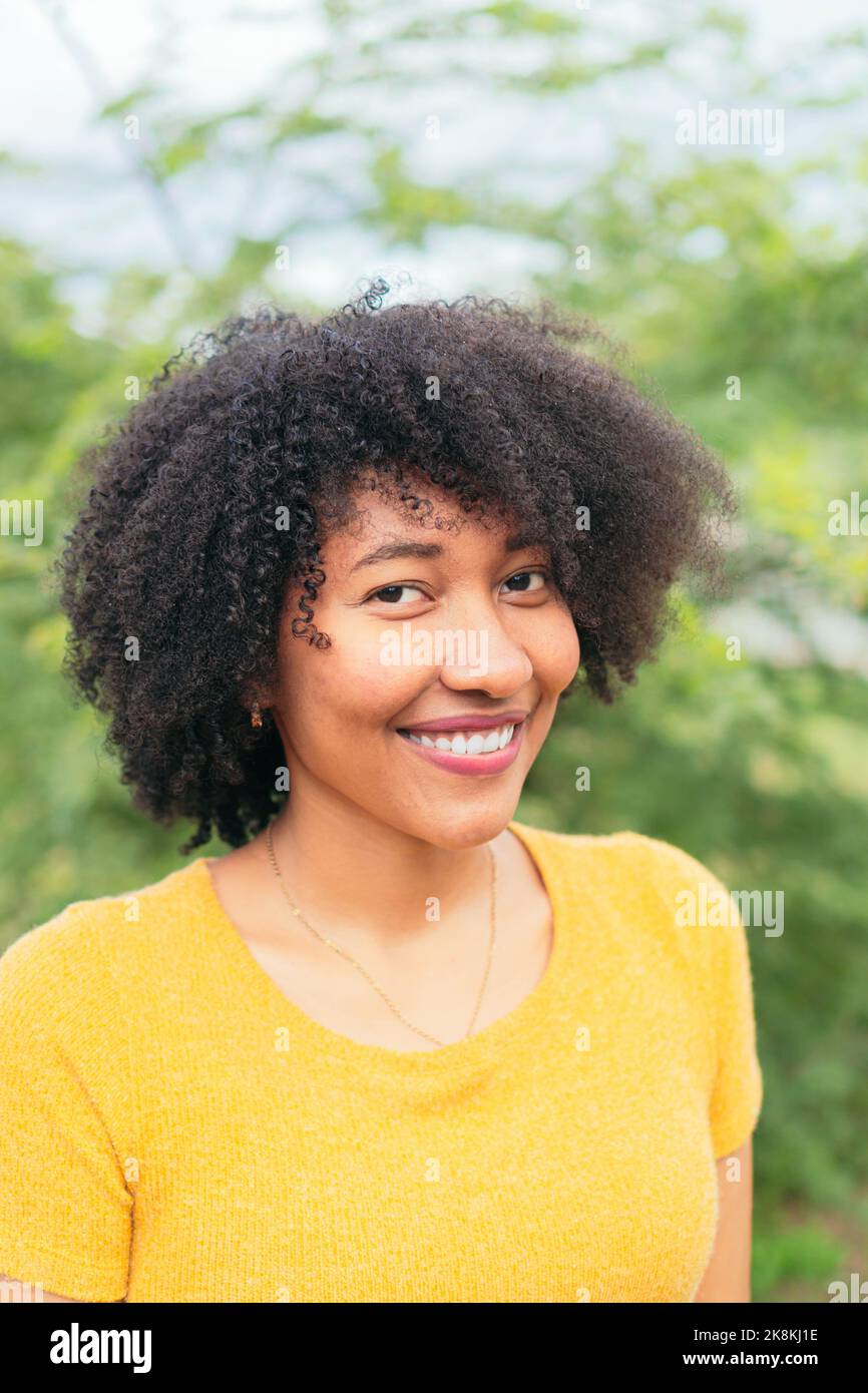 Portrait Latina woman looking at the camera while posing on a natural ...