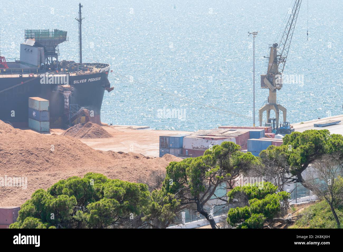 An aerial view of boat in the process of unloading wood chips carrier ...