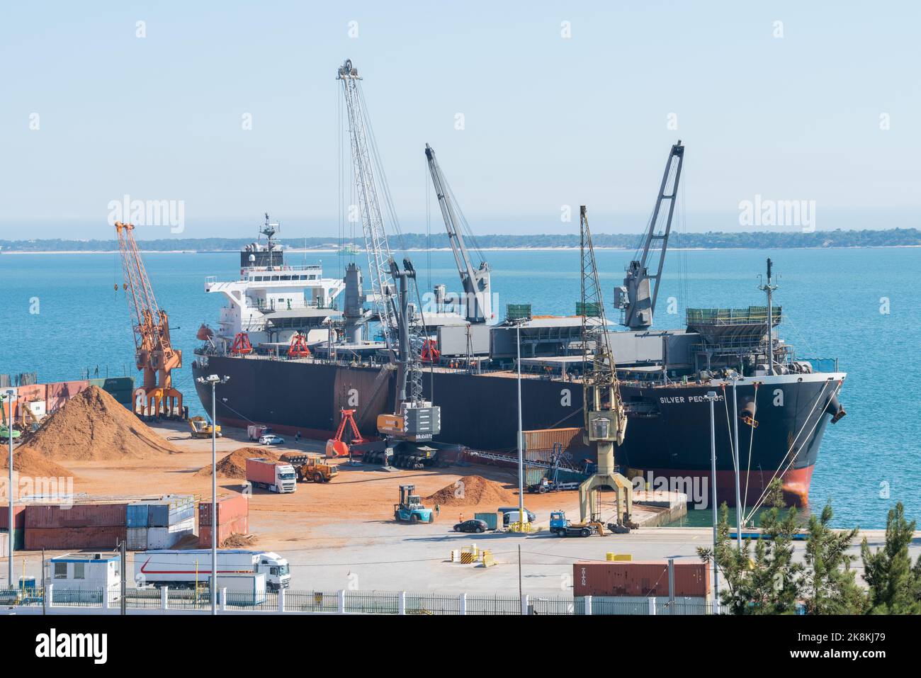 An aerial view of boat in the process of unloading wood chips carrier ...