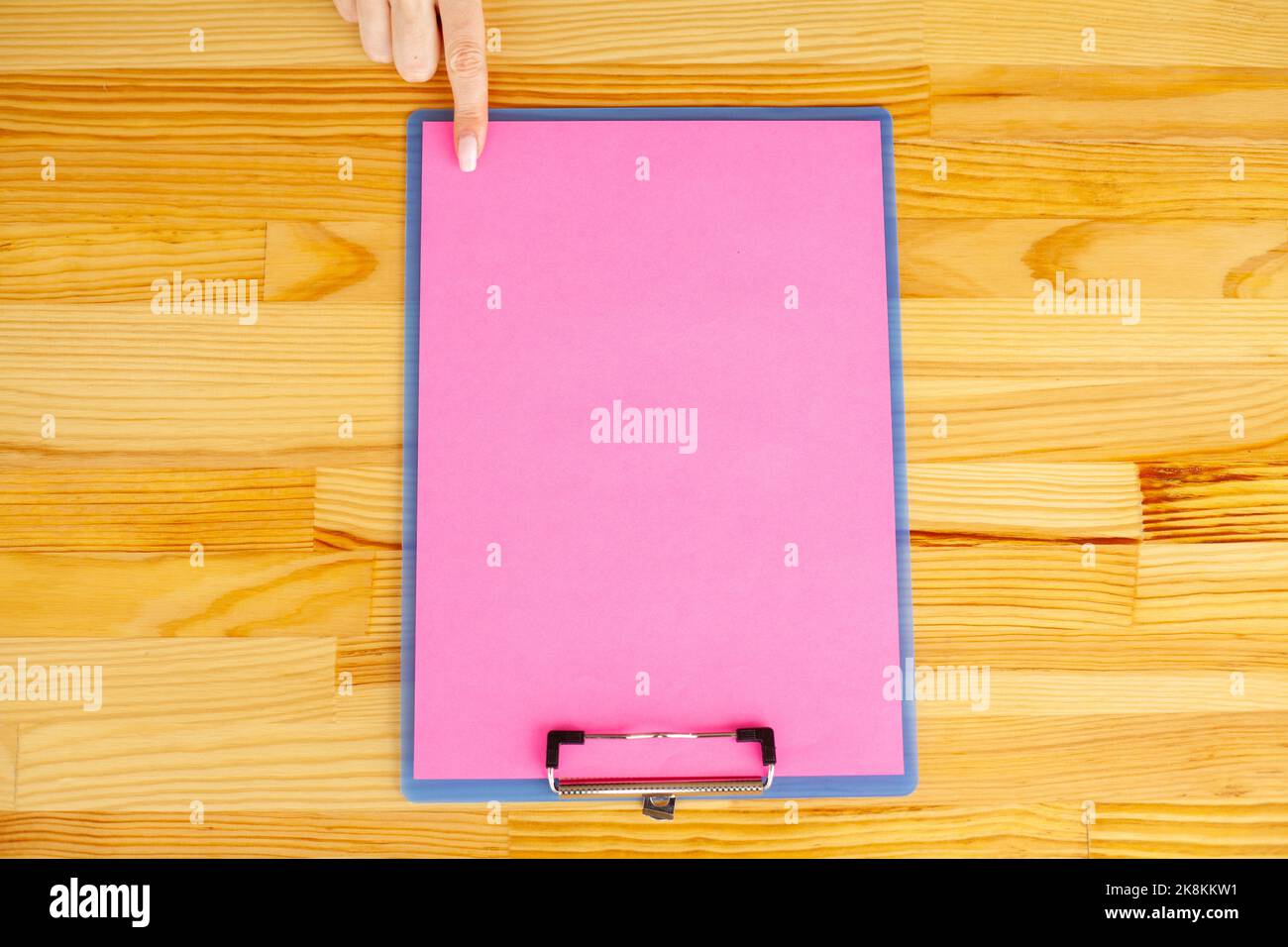 Office Hand Holding a Folder with a Pink Color Paper on the Background ...